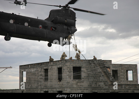 U.S. Army Ranger soldiers fast rope from a USA UH-60 Black Hawk ...
