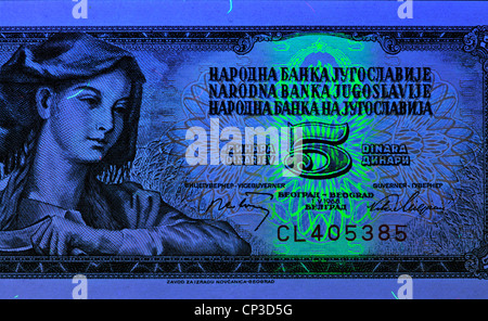 Banknote in ultraviolet light showing otherwise invisible security ...