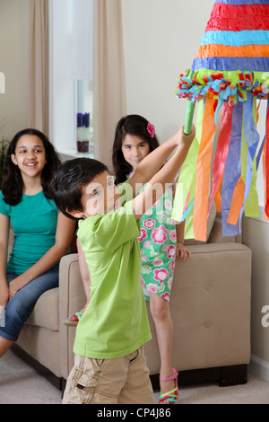 Children Hitting Pinata At Birthday Party Stock Photo - Alamy
