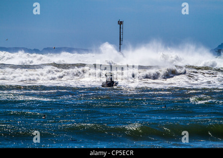 Giant wave crashing over jetty during storm along the North Sea coast ...