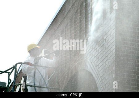 Man power washing building Stock Photo - Alamy