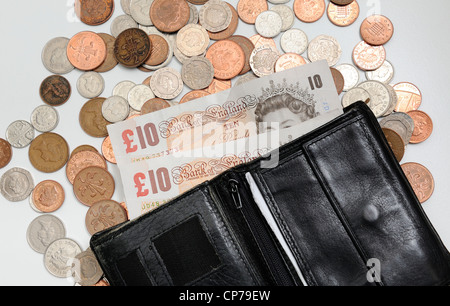 English notes and currency and a black wallet Stock Photo - Alamy