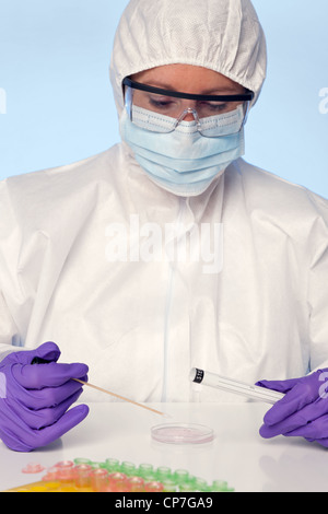 Forensic research. Forensic scientist taking a sample from a cigarette ...
