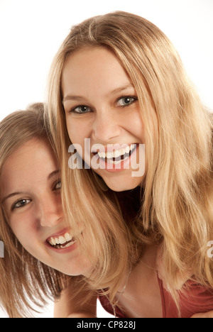 Two cheerful young women laughing and splashing in the clear blue water ...