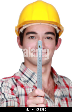 portrait of craftsman holding ruler Stock Photo - Alamy