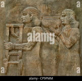 Two servants carrying a chair and a vase Neo Assyrian Sargon II 721-705 ...