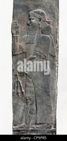 Figure holding a poppy flower Neo Assyrian palace of Sargon II 721-705 ...