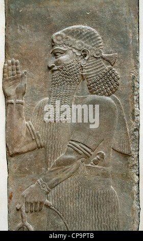 Figure holding a poppy flower Neo Assyrian palace of Sargon II 721-705 ...