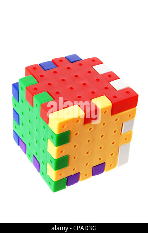 Square block puzzle toy on table with yellow wall background Stock ...