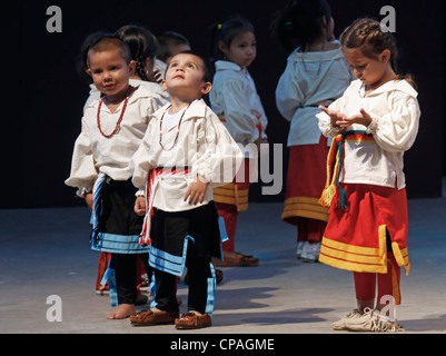 USA, North Carolina, Cherokee. Young Cherokee boy dressed in a ...