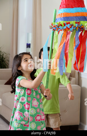 Children Hitting Pinata At Birthday Party Stock Photo - Alamy