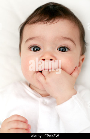 Baby biting on teether Stock Photo - Alamy