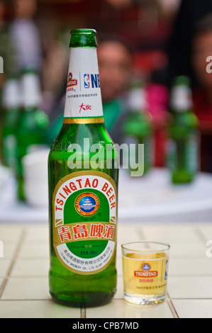 Bottle of Chinese Tsingtao Lager beer isolated on a white background ...