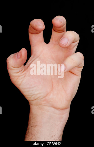 Clutching hand on black background Stock Photo - Alamy