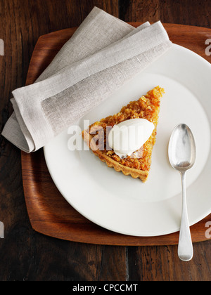 Slice of treacle tart with cream Stock Photo - Alamy