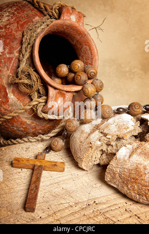 Antique wine jug, cross and rustic loaf of bread as christian symbols ...
