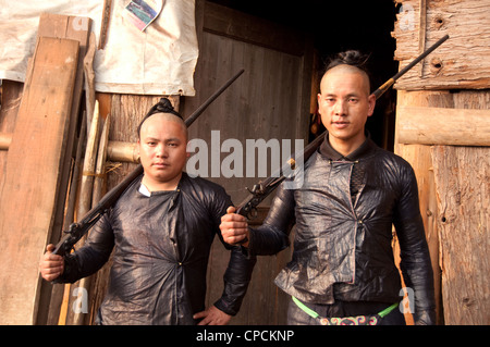 Two young Basha Miao men (Gun Men) with traditional hairstyles and ...