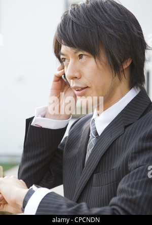 Japanese businessman talking on smartphone Stock Photo - Alamy