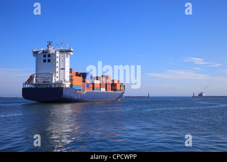 A container ship departs the port in Qingdao in eastern China's ...