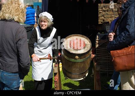 Woman making butter with butter churn. Old traditional method making of ...