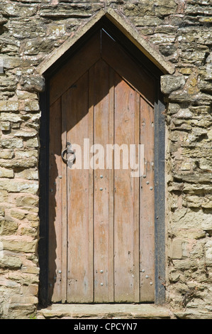 A rustic wooden gate set in the wall Stock Photo - Alamy