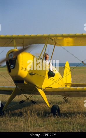 Pilot of ultra light biplane Kiebitz arranging his mustache after a ...