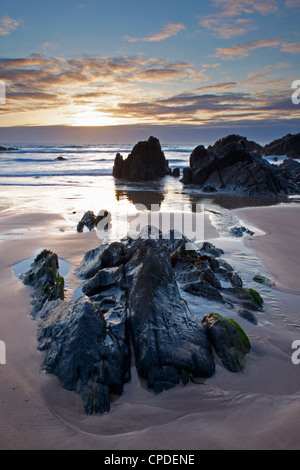 Rock formation at Combesgate Beach in north Devon surrounded by water ...