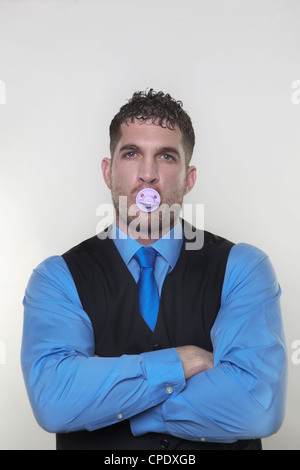 handsome man with a baby dummy in his mouth looking silly Stock Photo ...