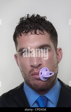 handsome man with a baby dummy in his mouth looking silly Stock Photo ...