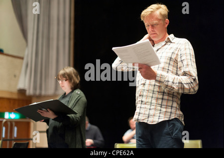 Actors reading their scripts on stage Stock Photo - Alamy