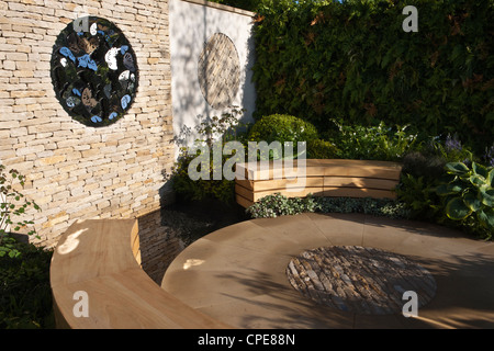 Cottage courtyard garden with cotswold dry stone wall and circular ...