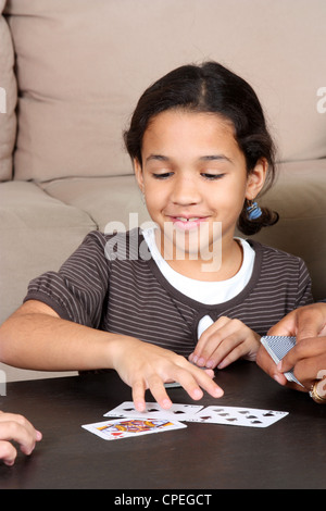 Family playing cards together around the table Stock Photo - Alamy