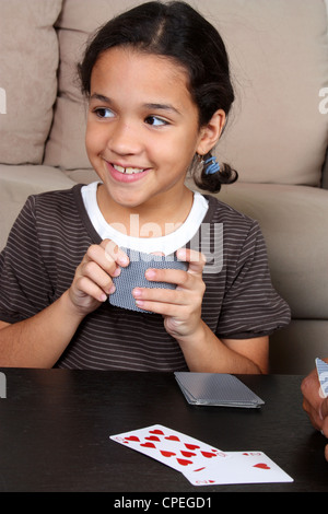 Family playing cards together around the table Stock Photo - Alamy