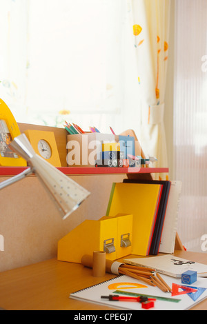 Stylish clock with stationery on color background Stock Photo - Alamy