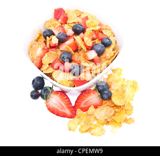A bowl of cornflakes with fruits on white background. Shallow depth of ...