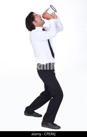Man in shirt shouting into megaphone and text come out Stock Photo - Alamy