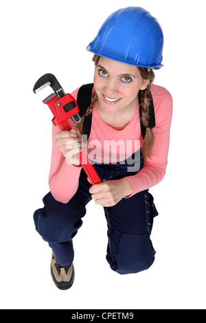 Female plumber kneeling with wrench Stock Photo - Alamy