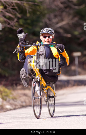 Adult male riding his recumbent bicycle along the waterfront in Port ...