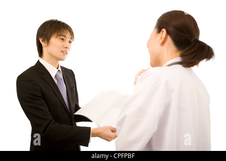 Pharmaceutical sales representative talking with female doctor in ...