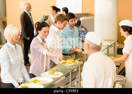 Business colleagues in cafeteria cook serve fresh healthy food meals ...