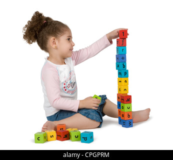 Side view of cute girl playing piano Stock Photo - Alamy