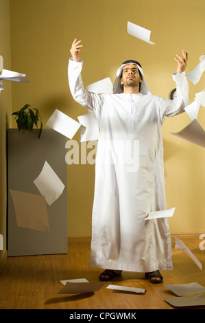 Serious businessman throwing paper in air isolated on white background ...