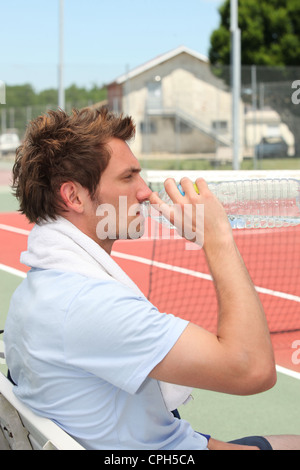 Tennis player drinking on the bench Stock Photo - Alamy