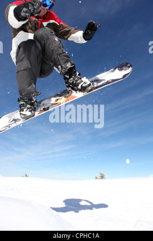 Snowboarder flying through the air Stock Photo - Alamy
