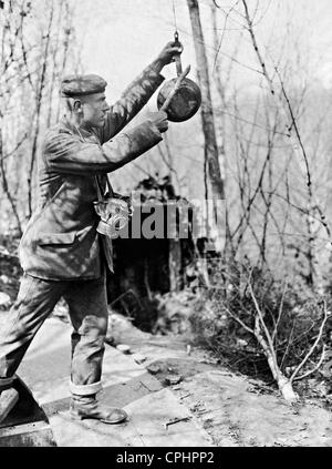 A gas alarm sounds on the front lines during World War I, signaling the ...