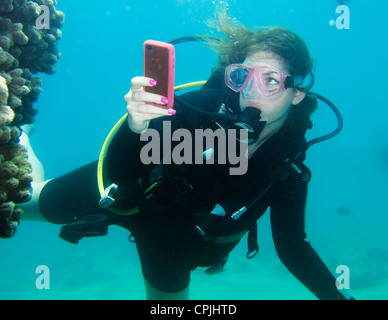 SCUBA diver using smartphone (Iphone) underwater Stock Photo - Alamy