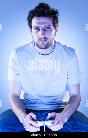 Serious Man Playing Videogames with Gamepad Stock Photo - Alamy