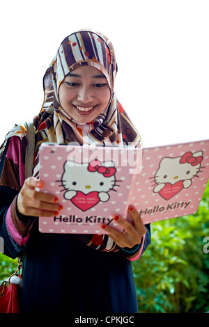Muslim girl with decorative Hello Kitty iPad cover Stock Photo - Alamy