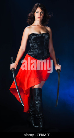 Female assassin in red skirt displays her power Stock Photo - Alamy