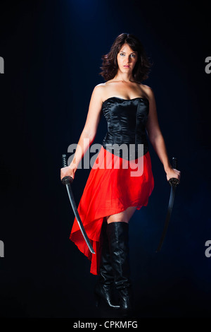 Female assassin in red skirt displays her power Stock Photo - Alamy